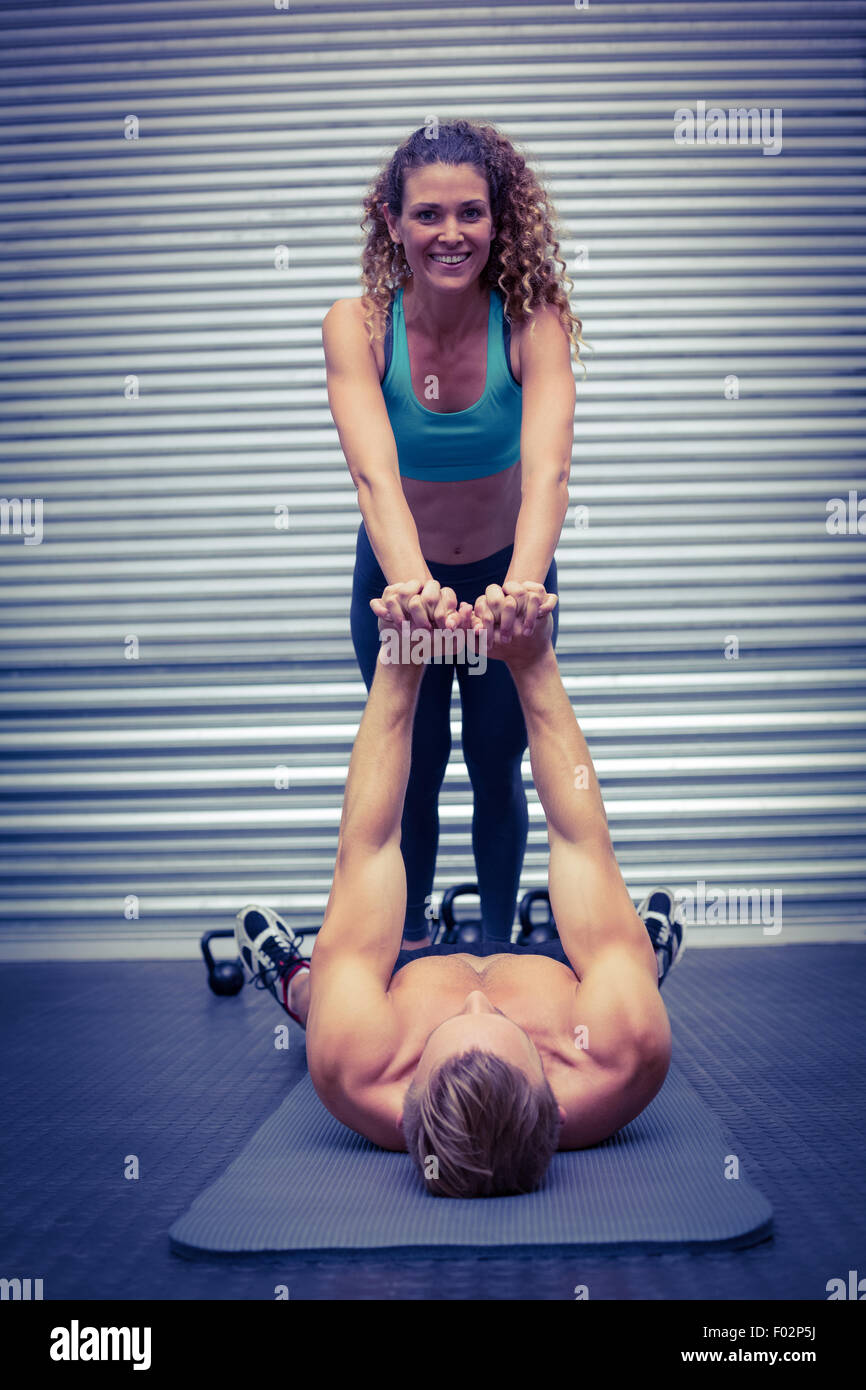 Muscular couple doing core exercises Stock Photo - Alamy