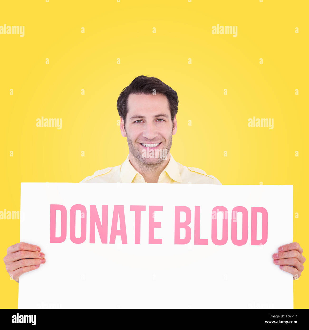 Composite image of attractive man smiling and holding poster Stock ...