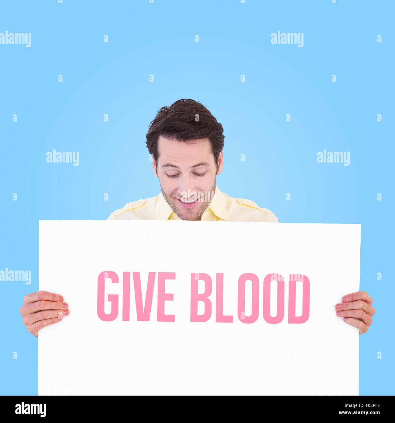 Composite image of attractive man smiling and holding poster Stock ...