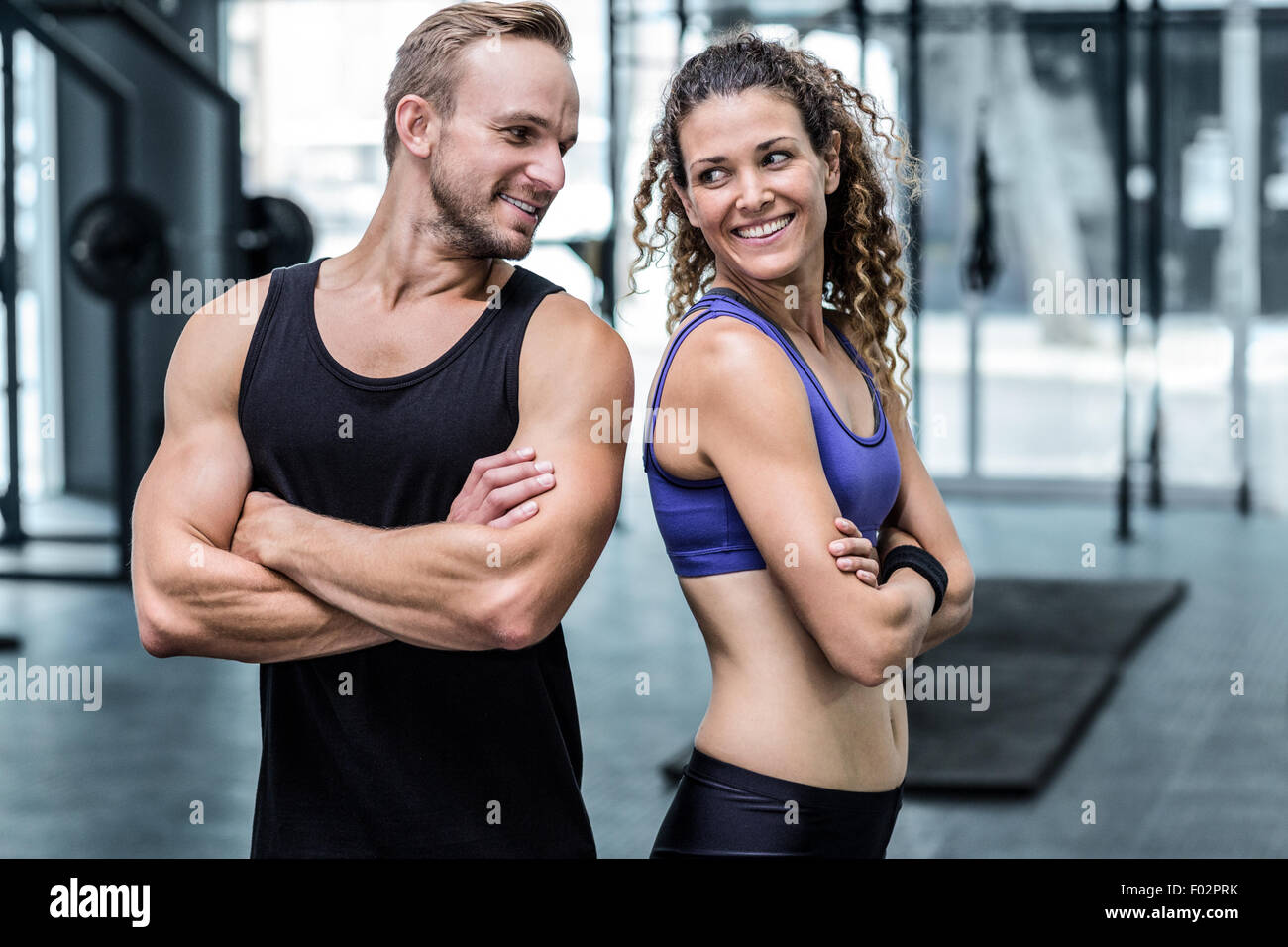 Muscular couple looking at each other Stock Photo - Alamy