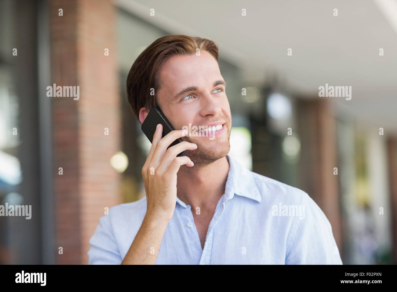 A happy smiling man calling Stock Photo - Alamy