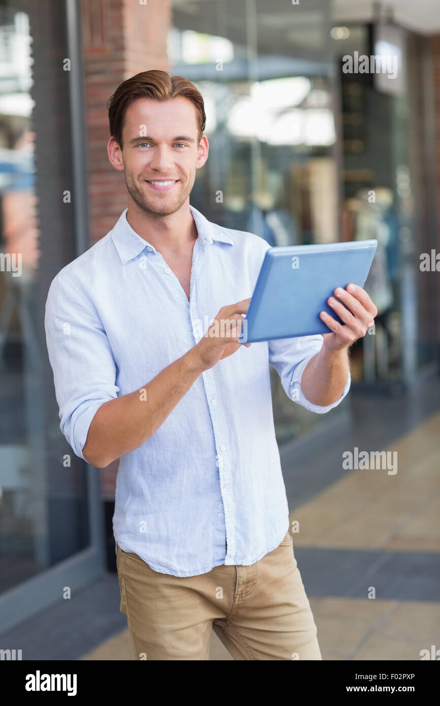 A happy smiling man using his tablet Stock Photo - Alamy