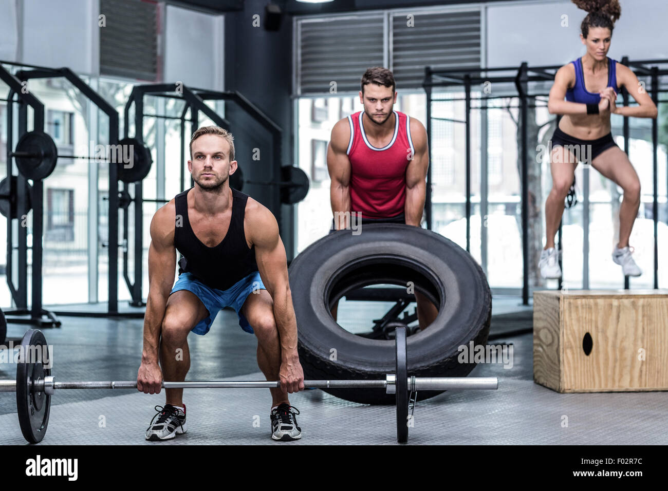 Three muscular athletes lifting and jumping Stock Photo - Alamy