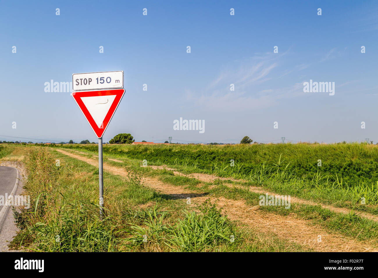 traffic signs and country roads - give way to 150 m signal with an ...