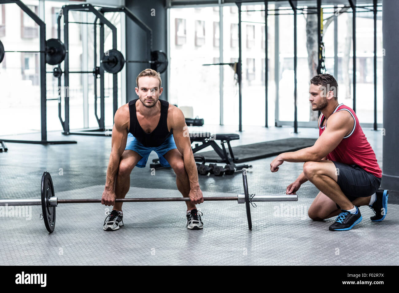 Portrait of a muscular man lifting a barbell Stock Photo - Alamy