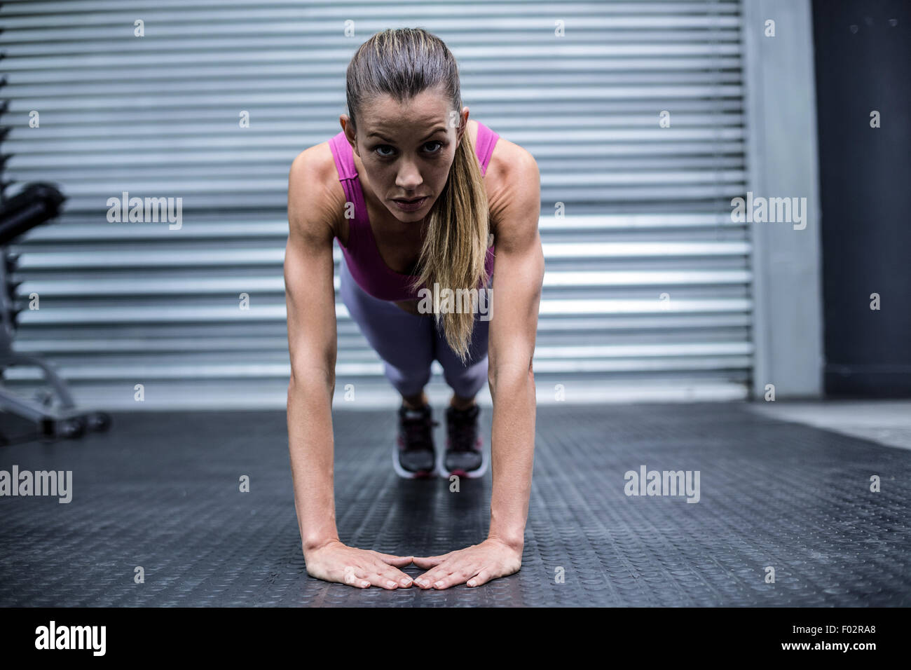 Muscular woman doing press up exercises Stock Photo - Alamy