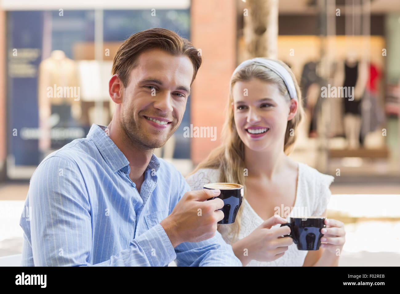 Cute couple drinking a coffee together Stock Photo - Alamy