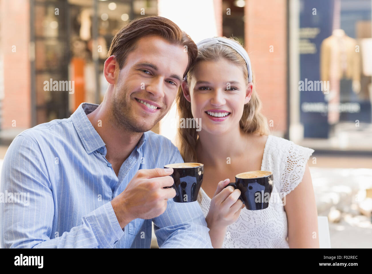 Cute couple drinking a coffee together Stock Photo - Alamy