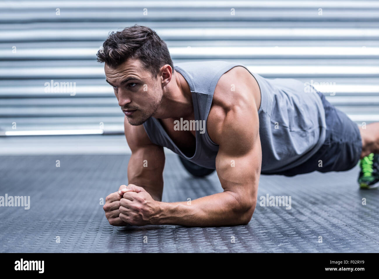 A muscular man on plank position Stock Photo - Alamy