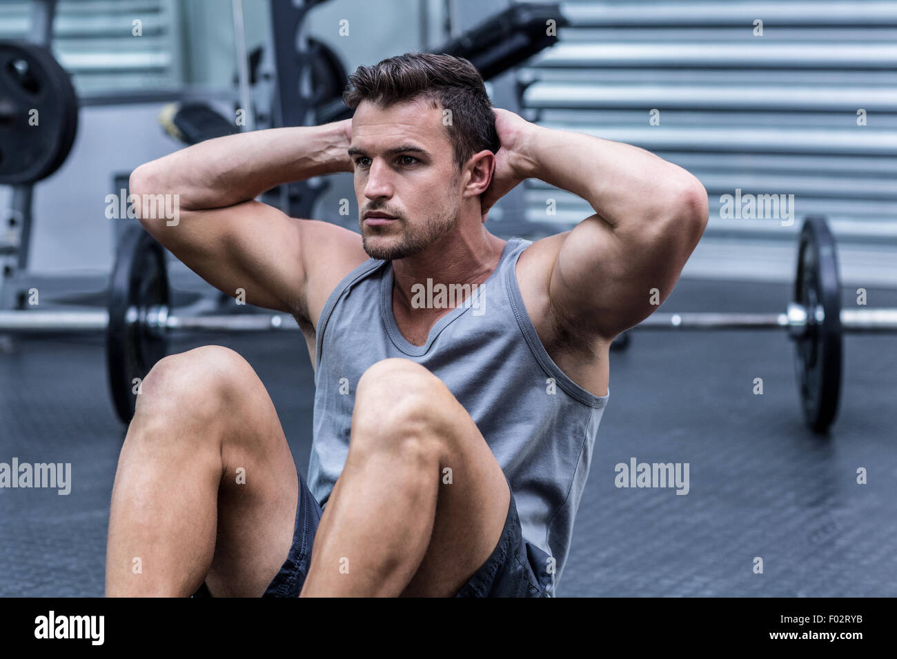 Muscular man doing abdominal crunch Stock Photo - Alamy
