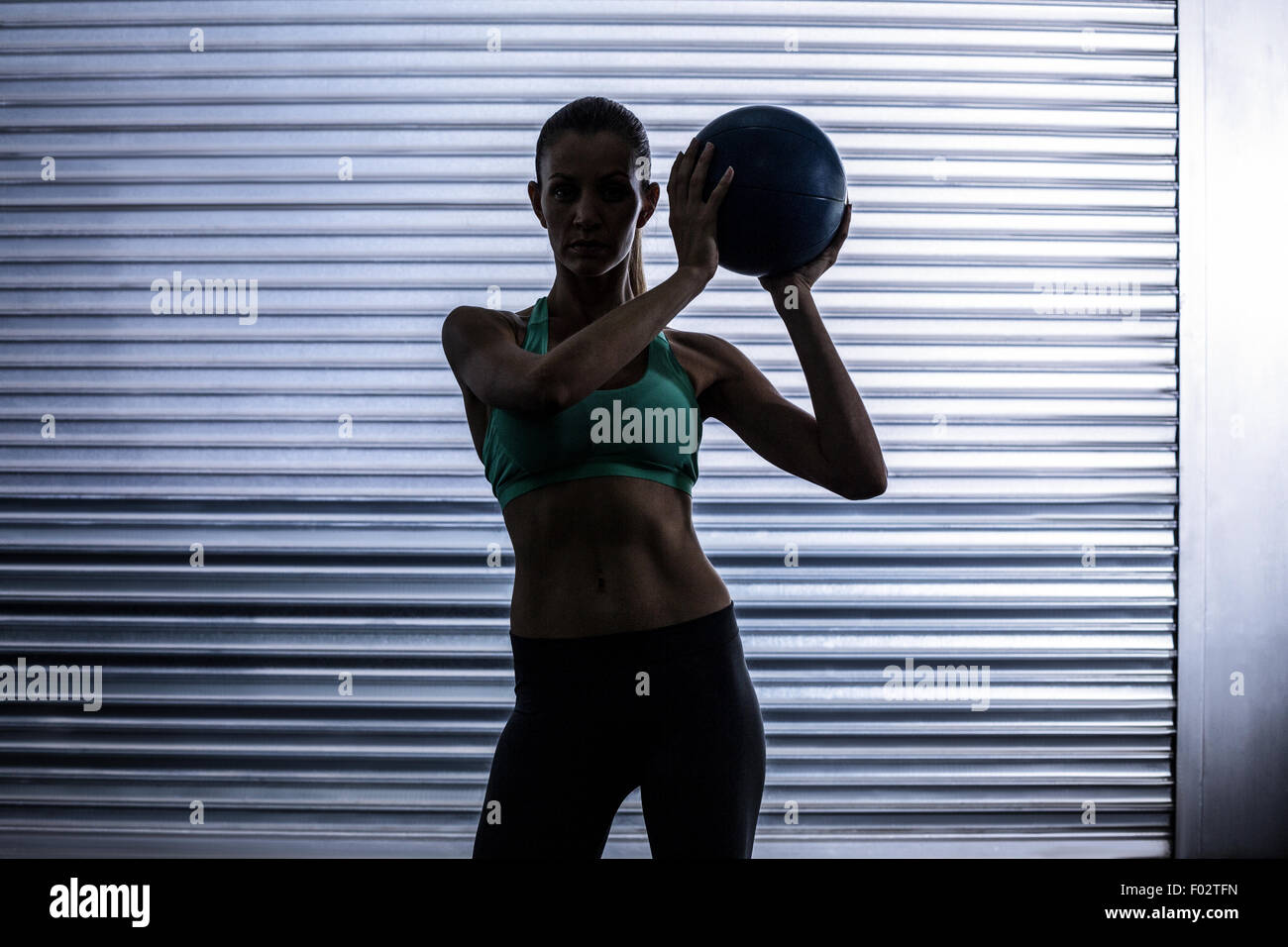 Muscular woman doing ball exercise Stock Photo - Alamy
