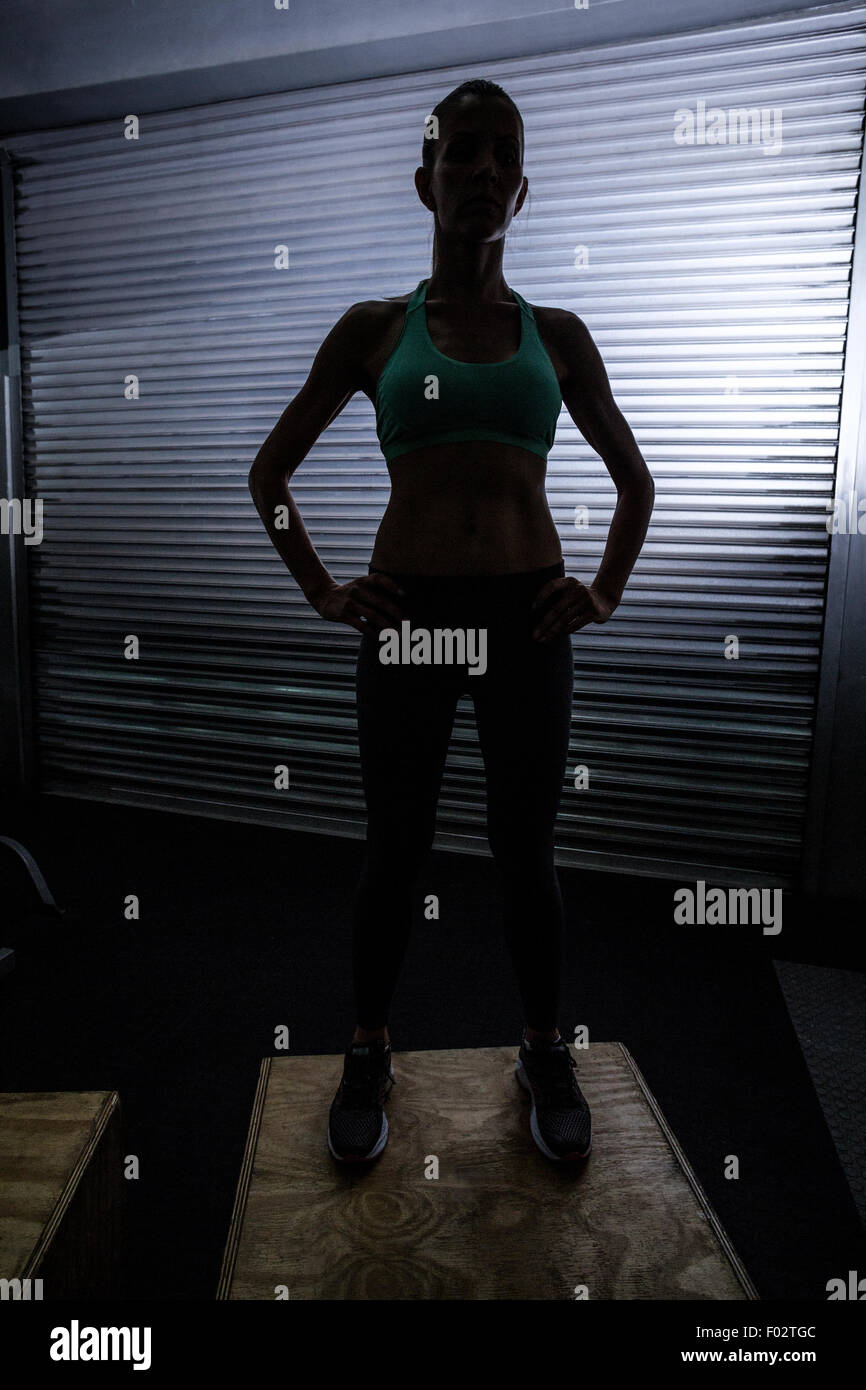 Muscular woman standing on a box Stock Photo - Alamy