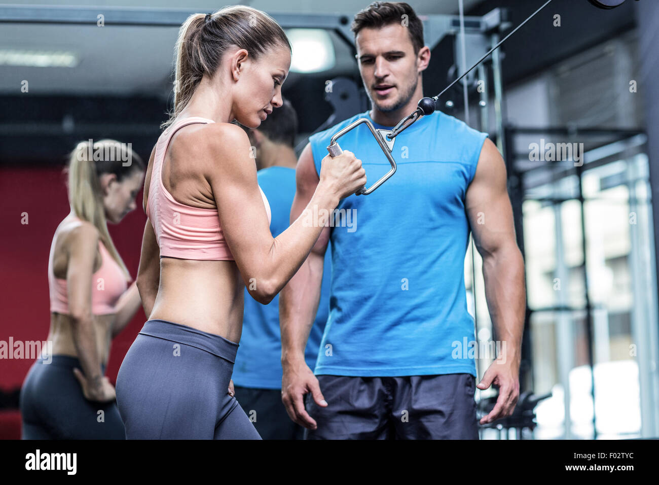 Muscular woman doing pulling exercises Stock Photo - Alamy
