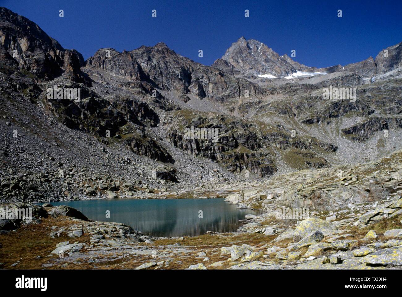 Alpine lake in Locana Valley with Monte Ciarforon in the background ...