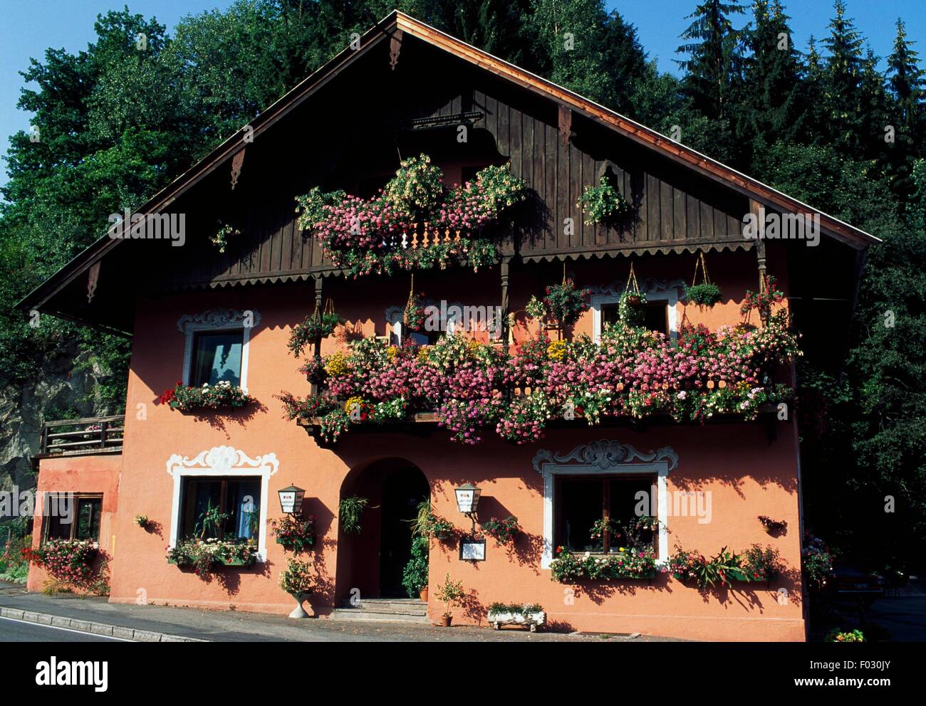 Building with balconies and teeming flower boxes in Kitzbuhel, Tyrol ...
