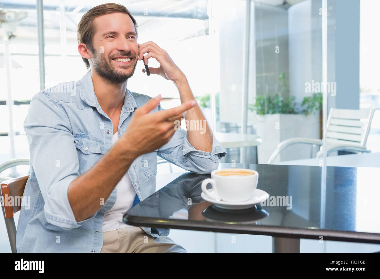 Young happy man talking on the phone Stock Photo - Alamy