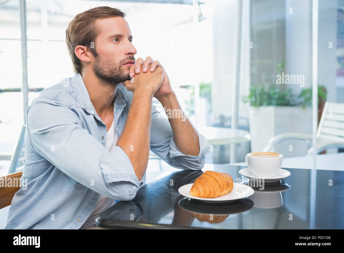 Young thoughtful man looking in the distance Stock Photo - Alamy