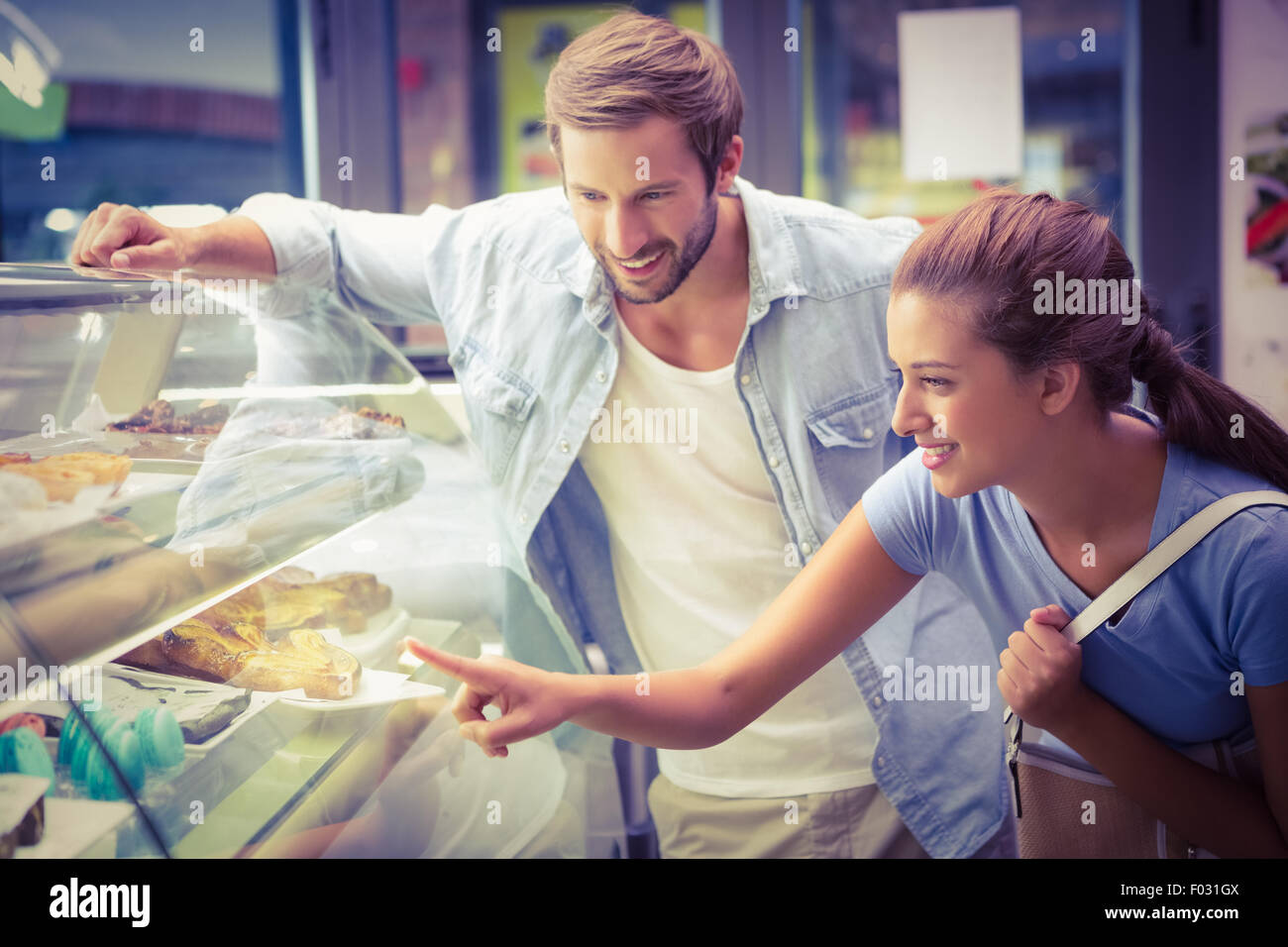 Young happy couple choosing cake Stock Photo - Alamy