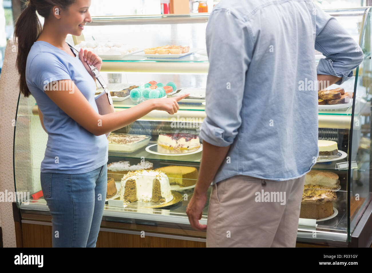 Young happy couple choosing cake Stock Photo - Alamy