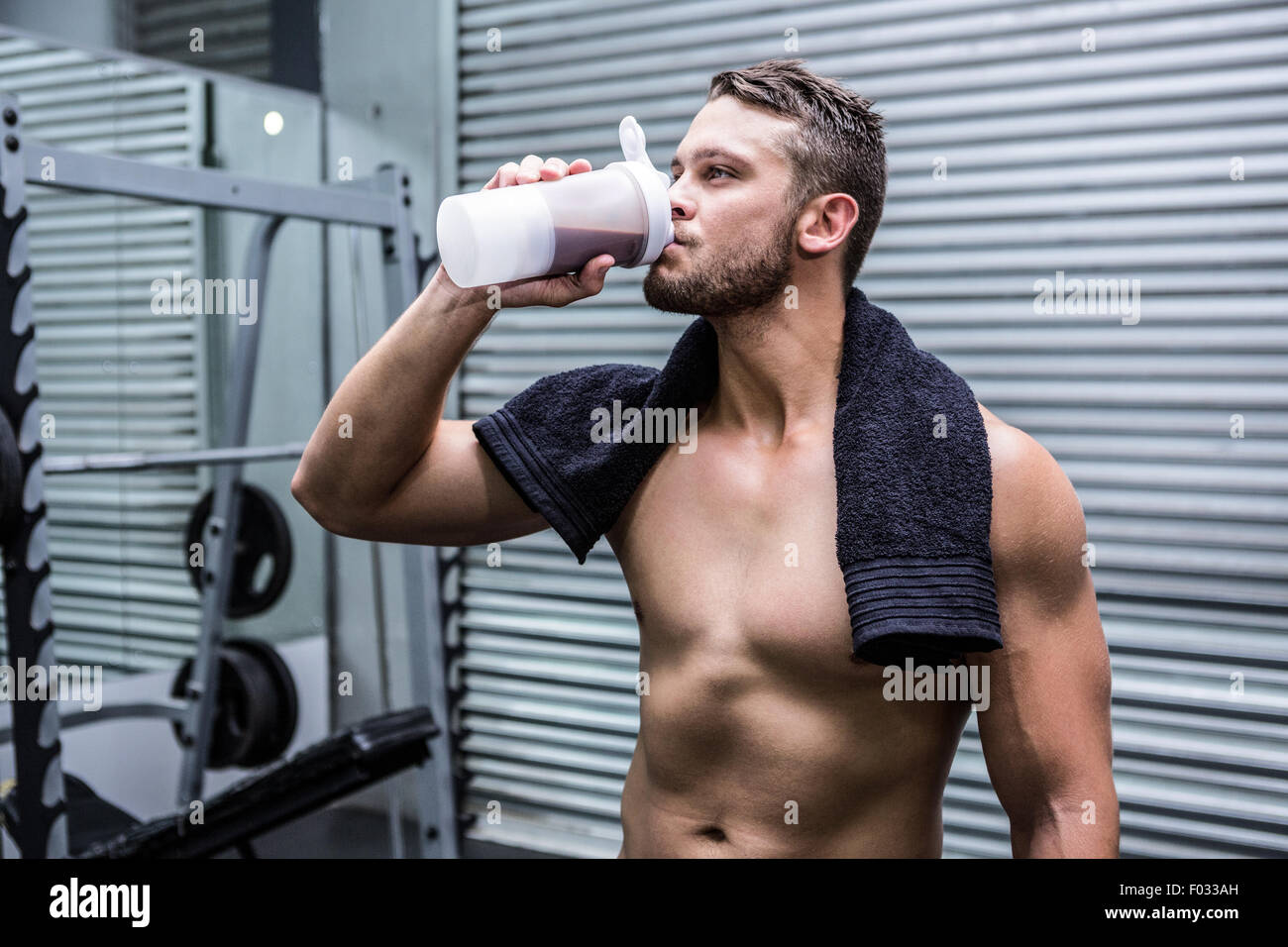 Muscular man drinking protein cocktail Stock Photo - Alamy