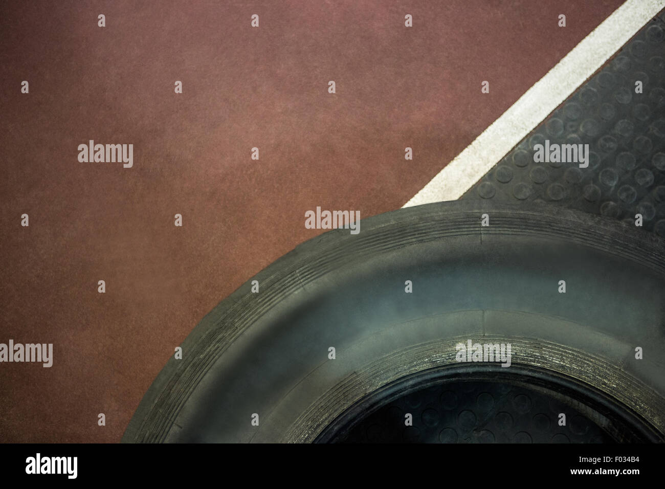 Close up view of tire next to race track Stock Photo - Alamy