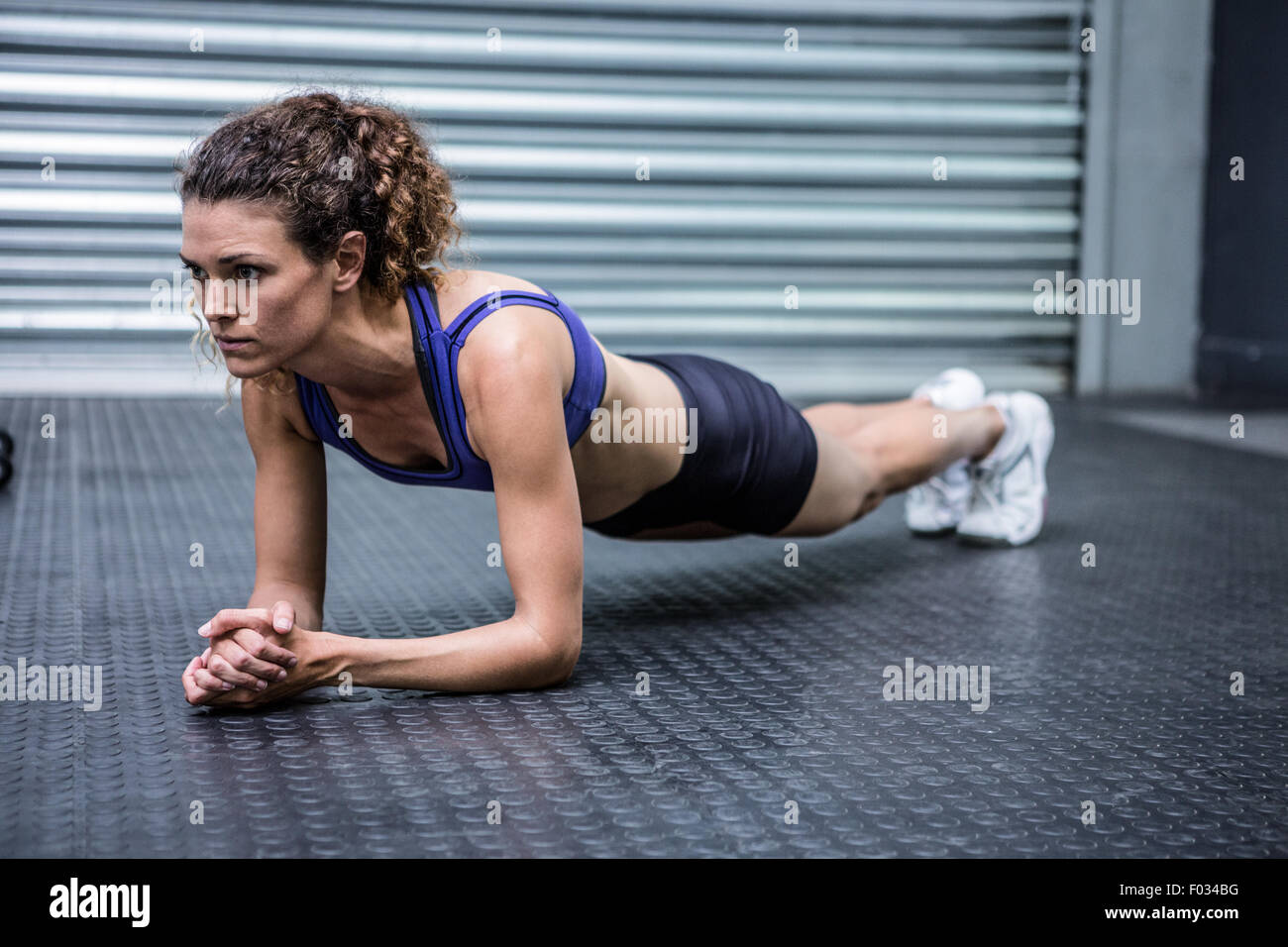 Muscular woman doing push-ups Stock Photo - Alamy