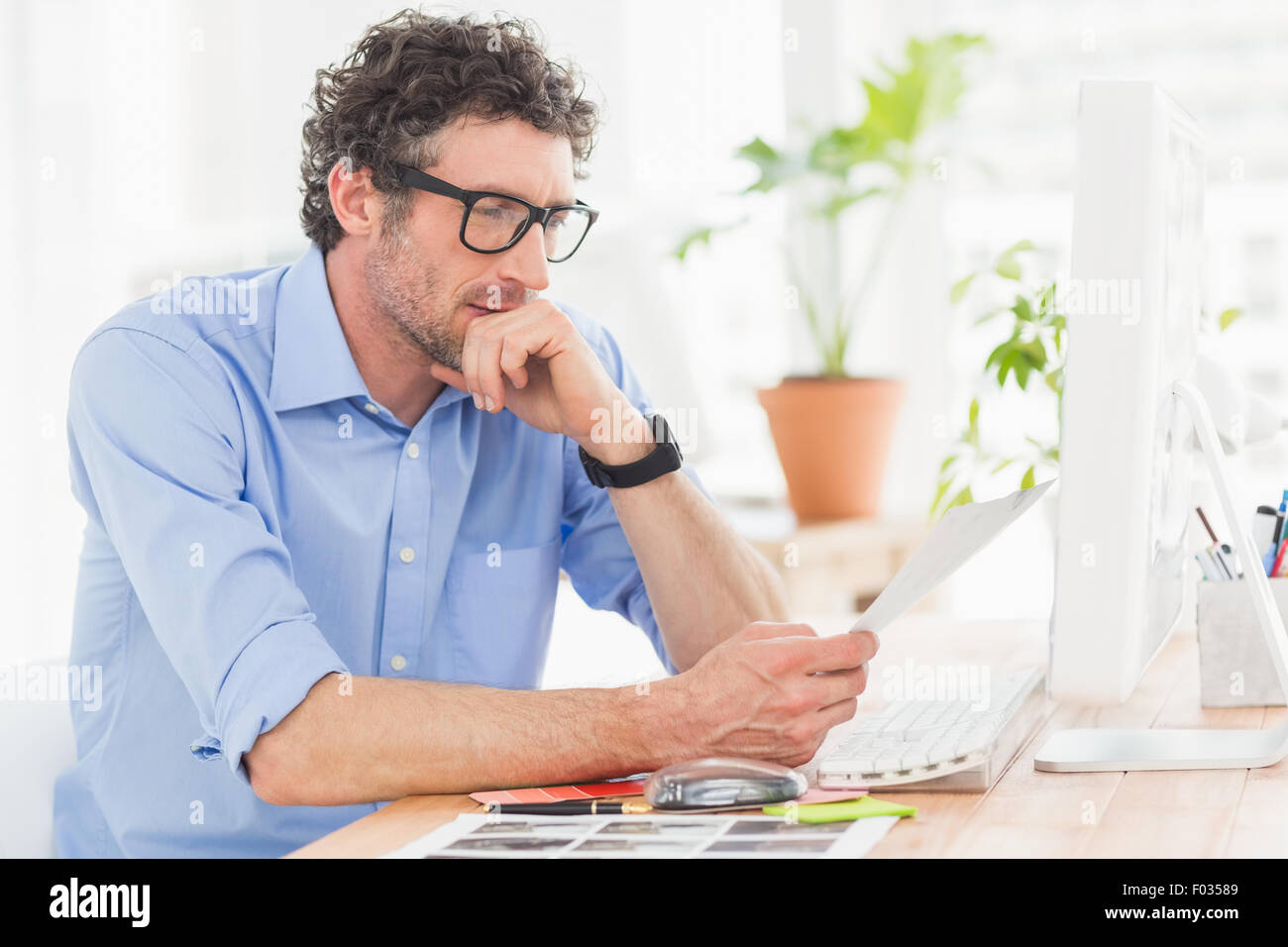 Casual businessman using computer in office Stock Photo - Alamy