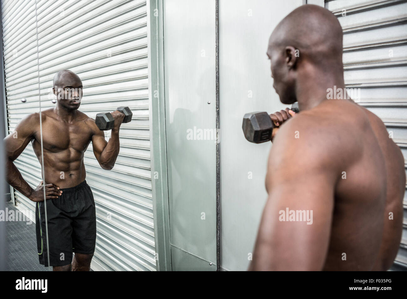 Young Bodybuilder doing weightlifting Stock Photo - Alamy