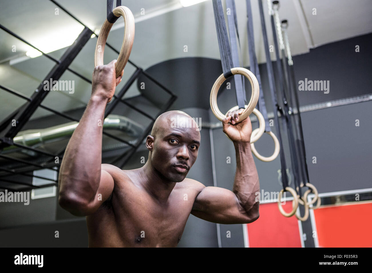Young Bodybuilder lifting himself up and down Stock Photo - Alamy