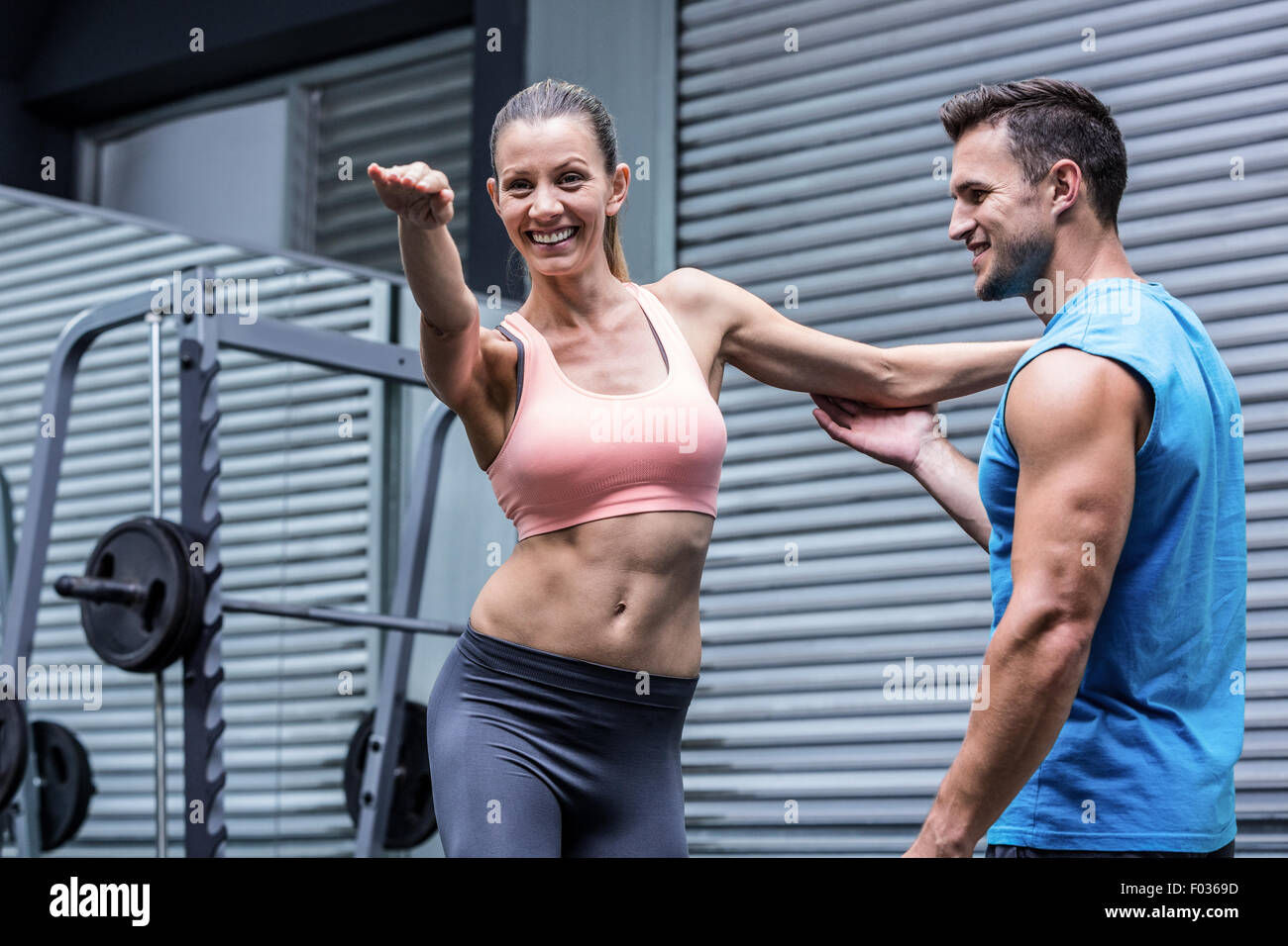 Young Bodybuilder training a young woman Stock Photo - Alamy