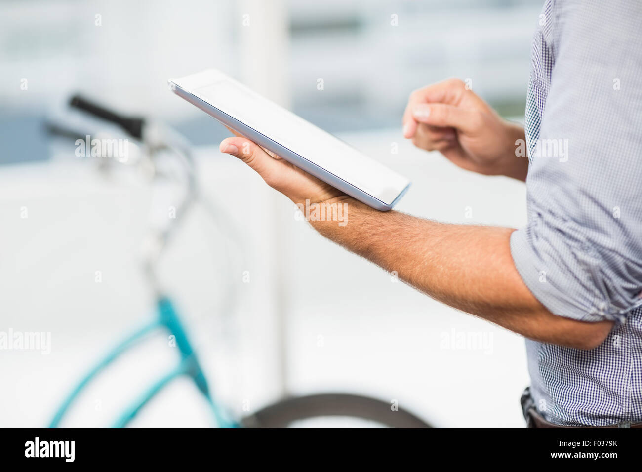 Businessman scrolling on his tablet in the office Stock Photo - Alamy