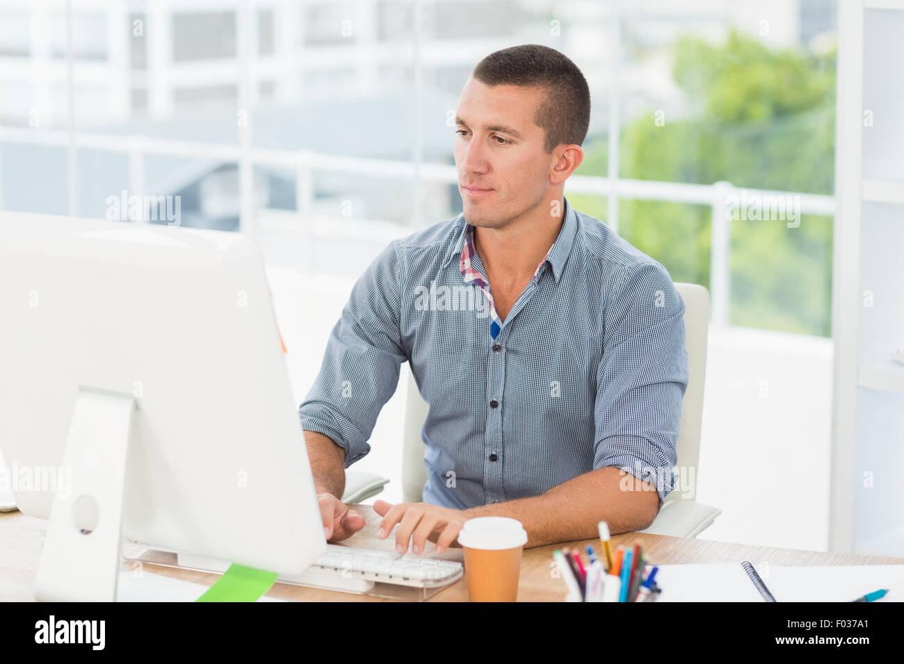 Handsome businessman typing on a computer Stock Photo - Alamy