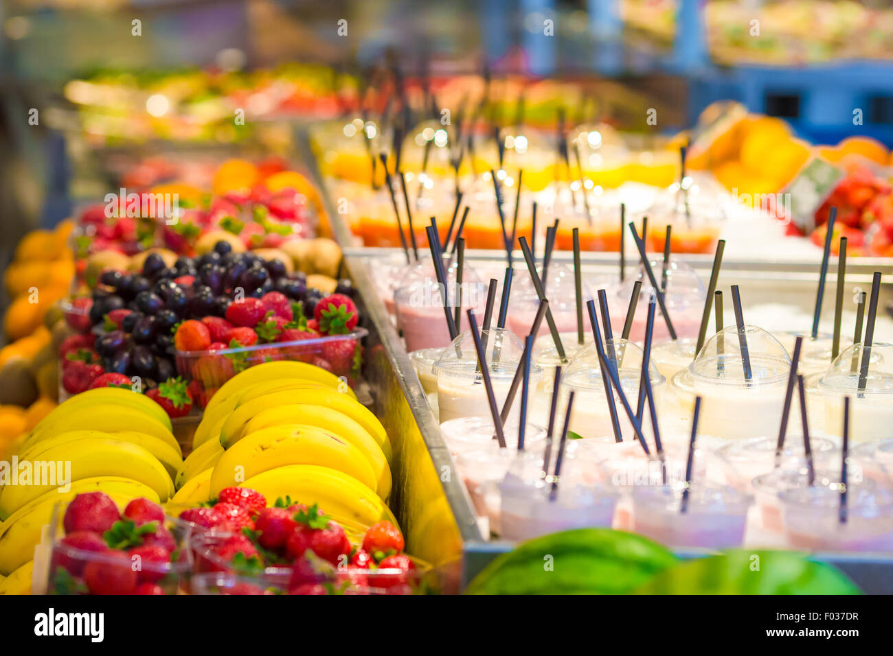 Delicious sweet cocktails and fresh fruits in the shop with takeaway ...