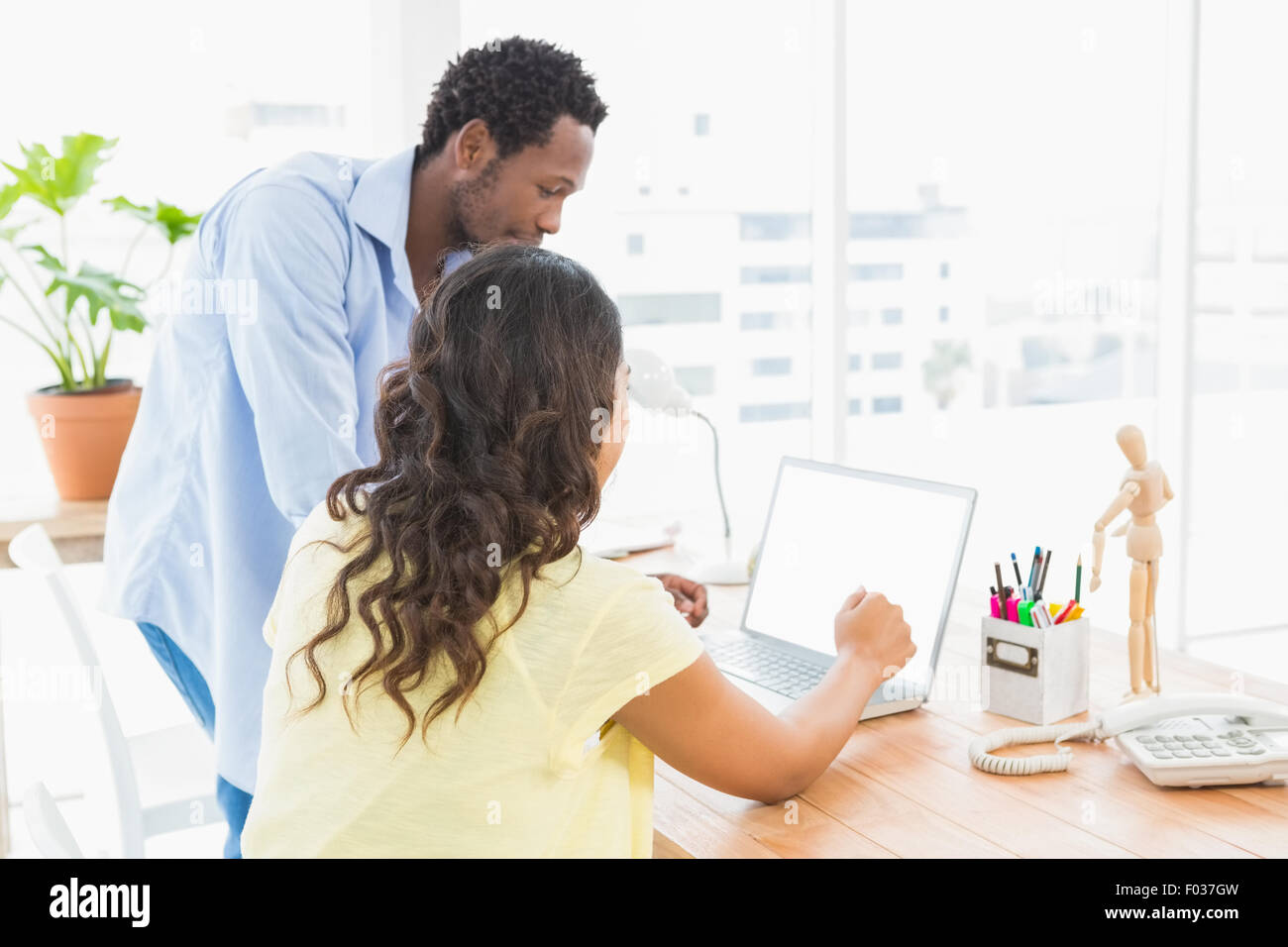 Teamwork using laptop Stock Photo - Alamy