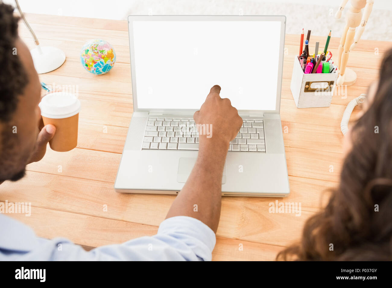 Pointing laptop screen colleagues hi-res stock photography and images ...