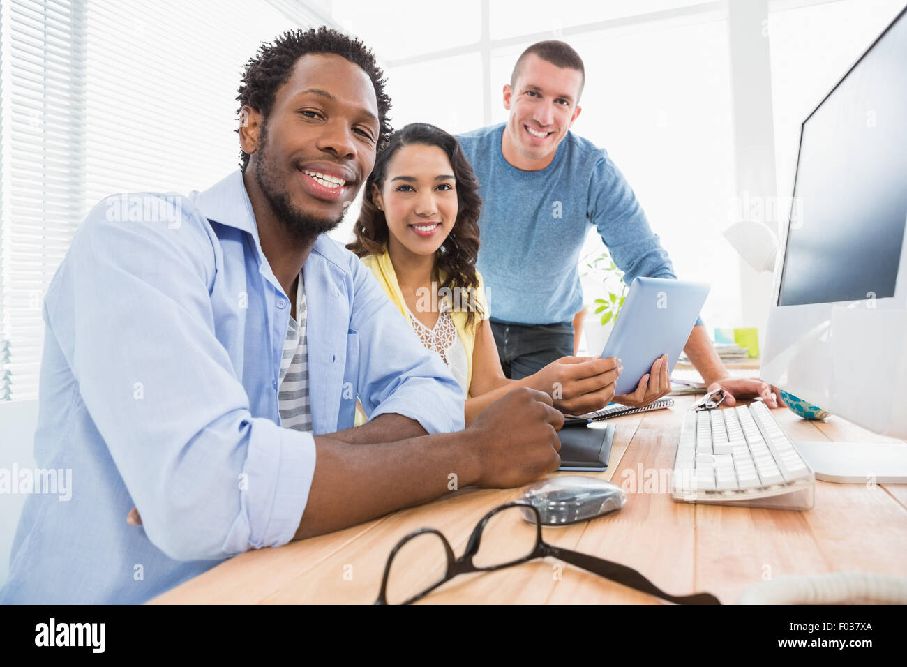 Portrait of smiling colleagues looking at camera Stock Photo - Alamy