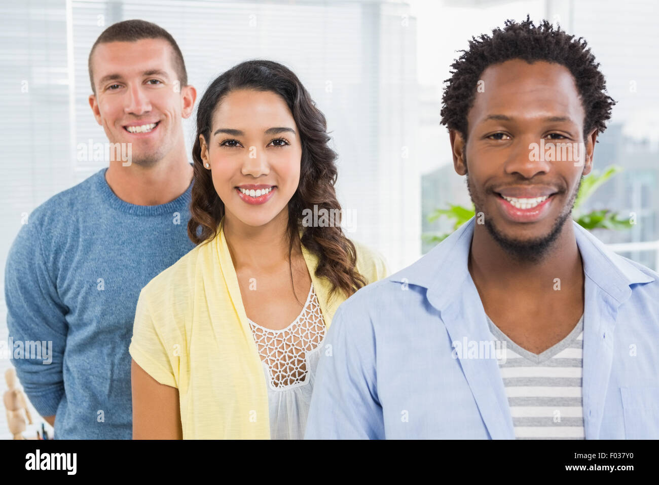 Portrait of smiling colleagues looking at camera Stock Photo - Alamy