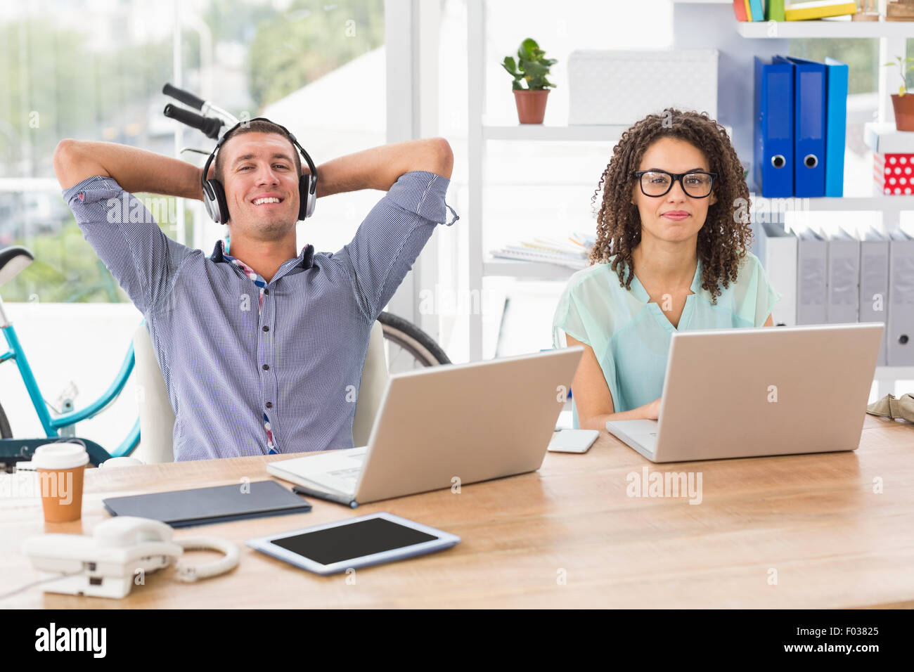 Relaxed businessman listening to music Stock Photo - Alamy