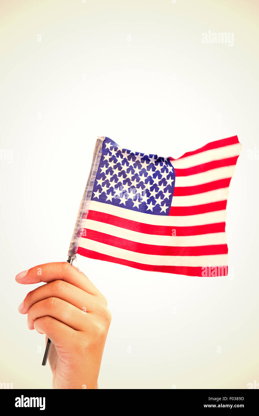 Composite image of hand waving american flag Stock Photo - Alamy