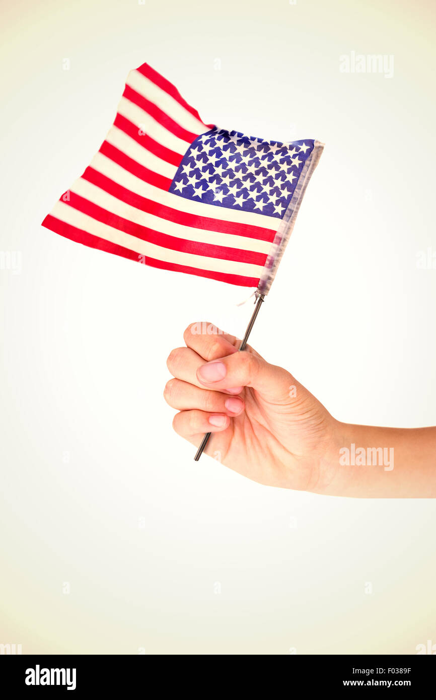Composite image of hand waving american flag Stock Photo - Alamy
