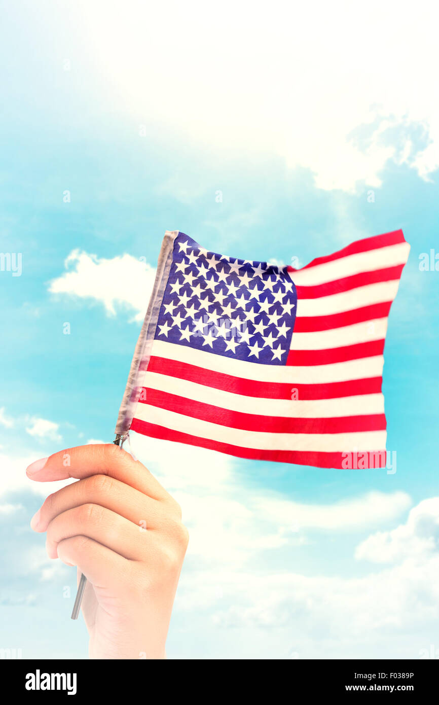 Composite image of hand waving american flag Stock Photo - Alamy