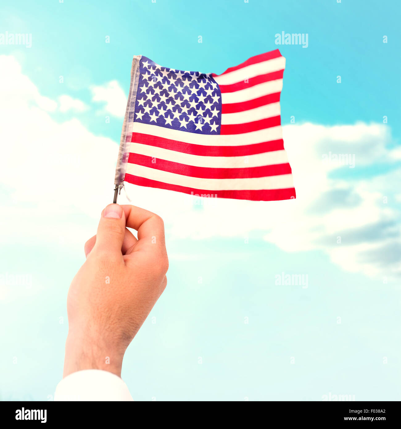 Composite image of hand waving american flag Stock Photo - Alamy