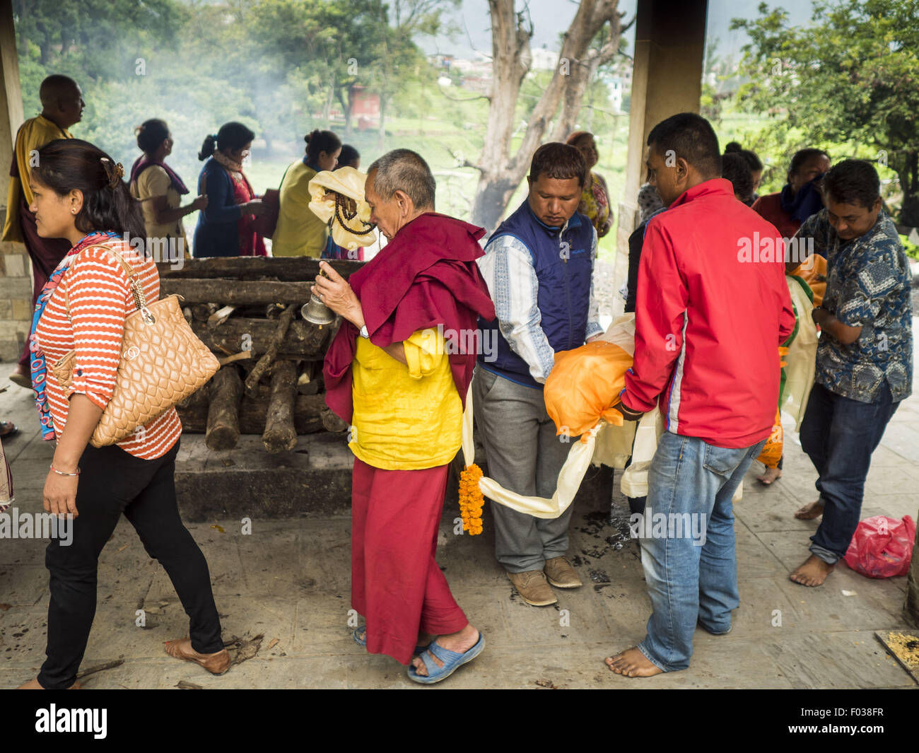 Nepal. 5th Aug, 2015. A Buddhist monk leads the family of the deceased ...