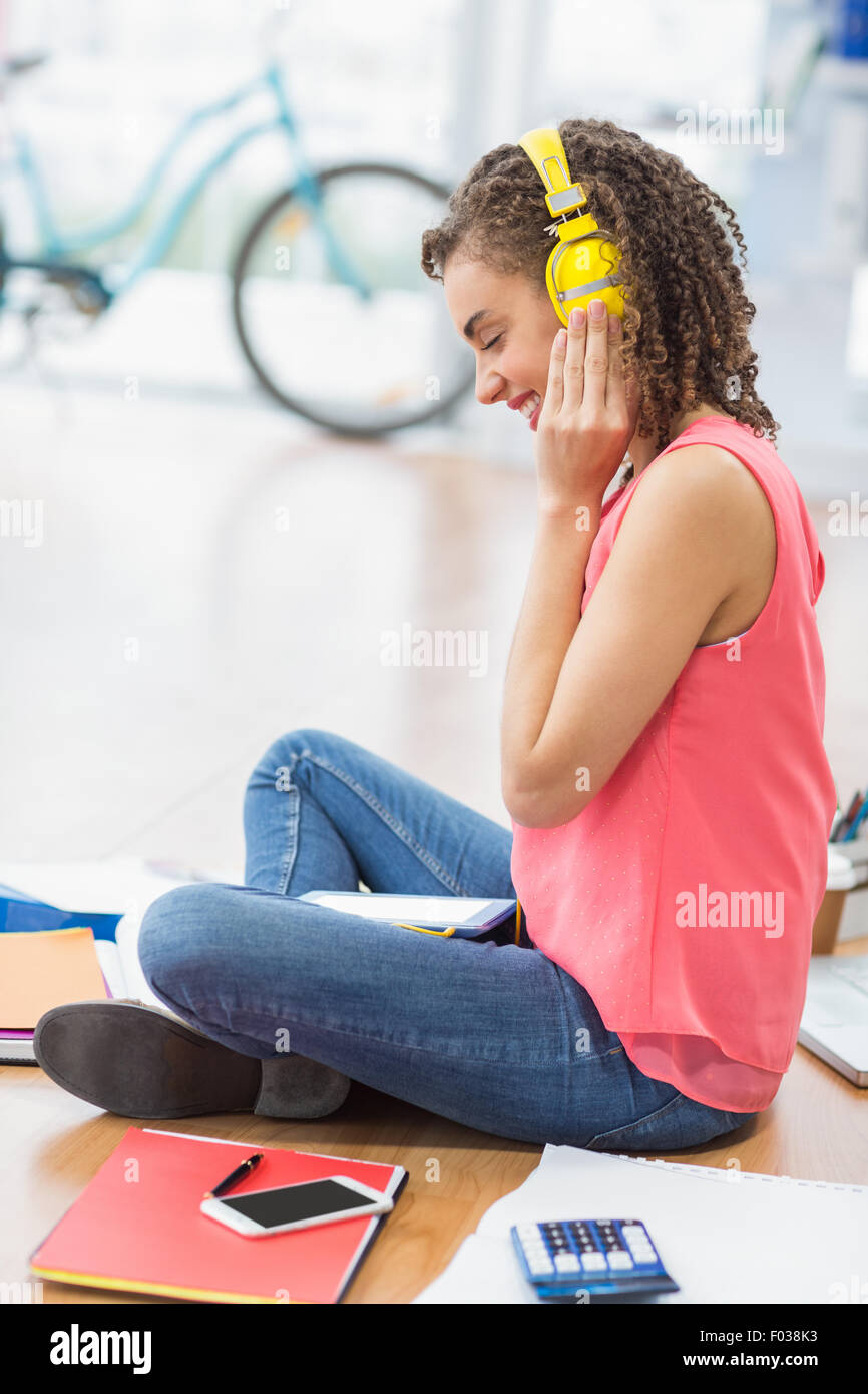 Young creative businesswoman listening to music Stock Photo - Alamy
