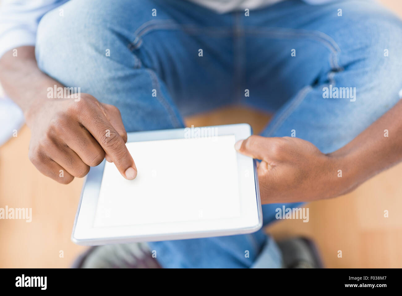 Young creative businessman scrolling on the tablet Stock Photo - Alamy