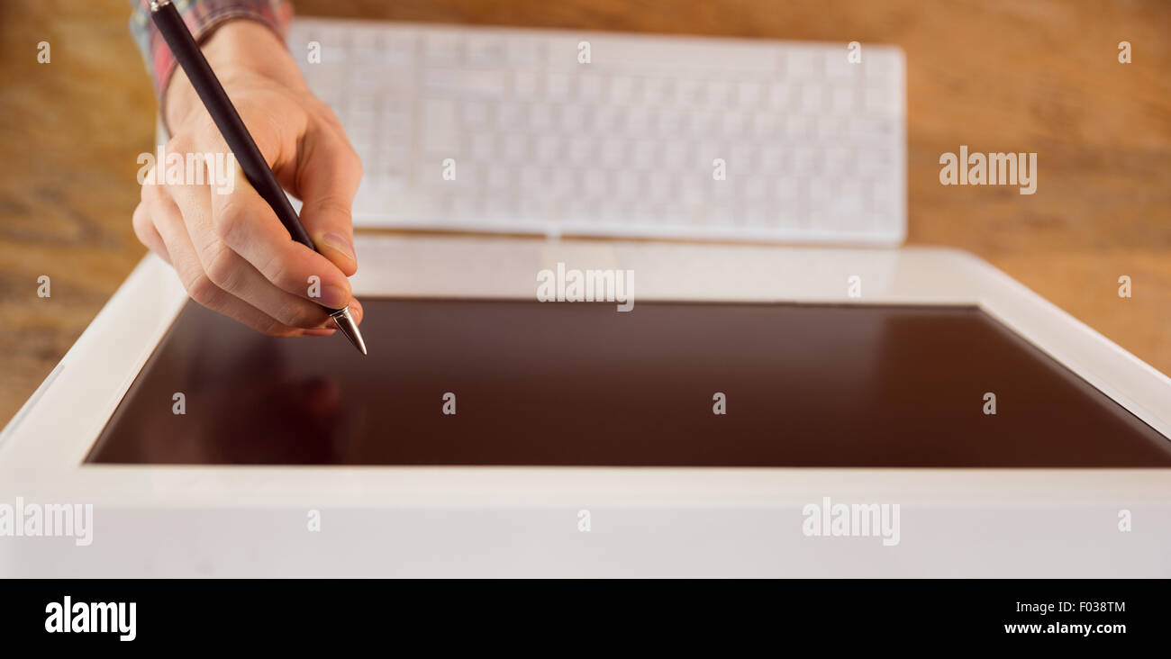 Businessman pointing at computer with pen Stock Photo - Alamy