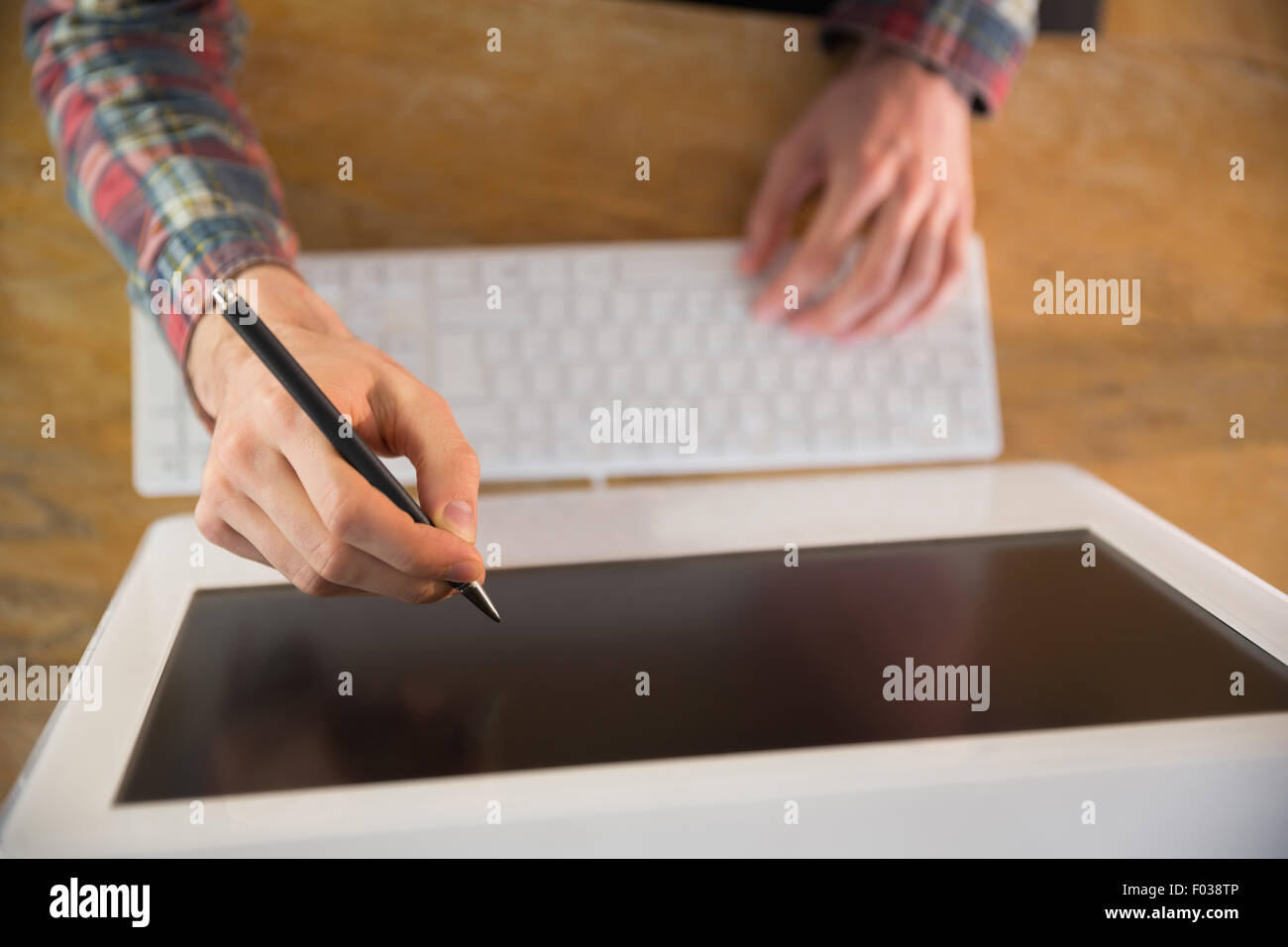 Businessman pointing at computer with pen Stock Photo - Alamy