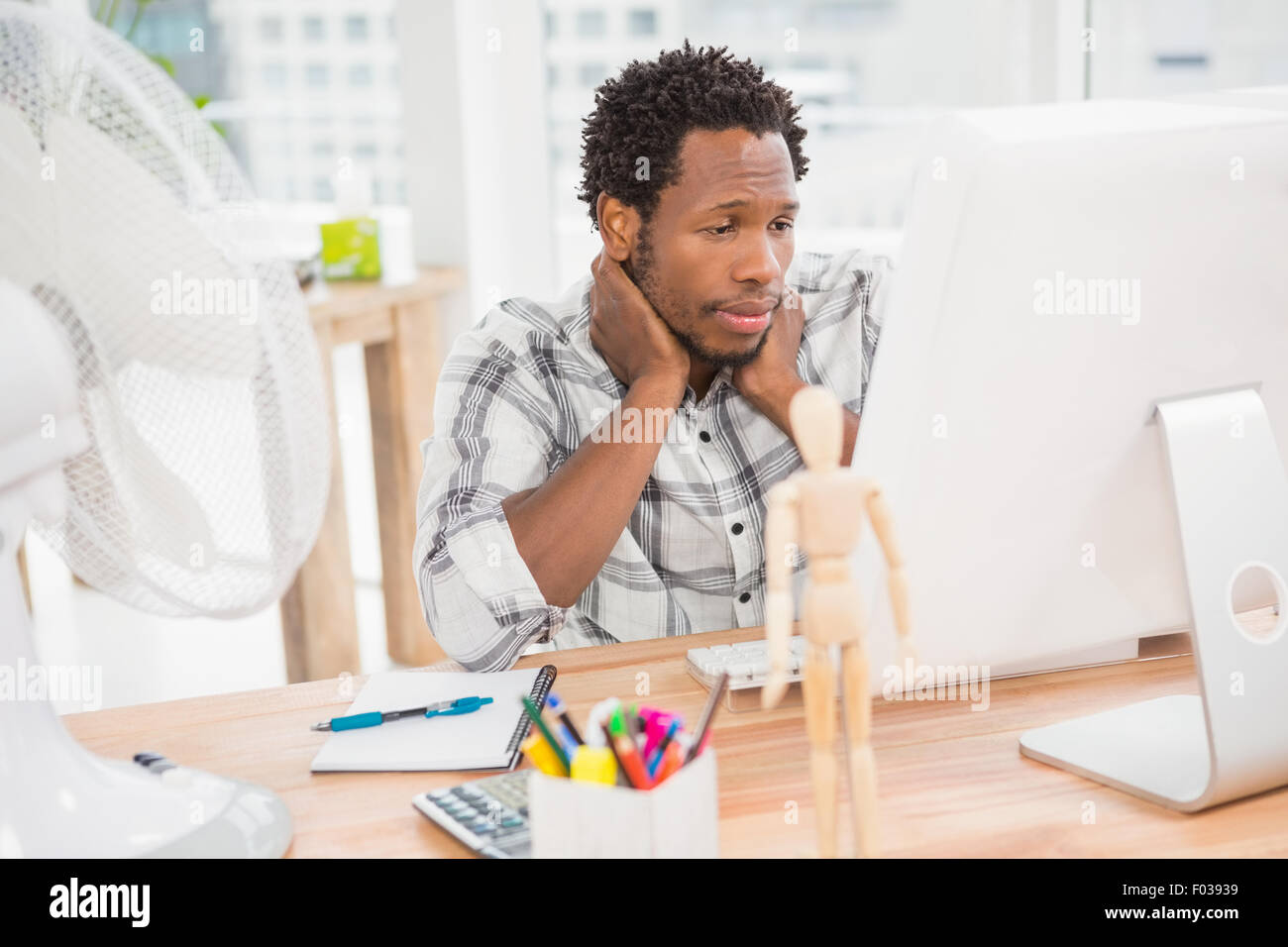 Young businessman looking at his computer screen Stock Photo - Alamy