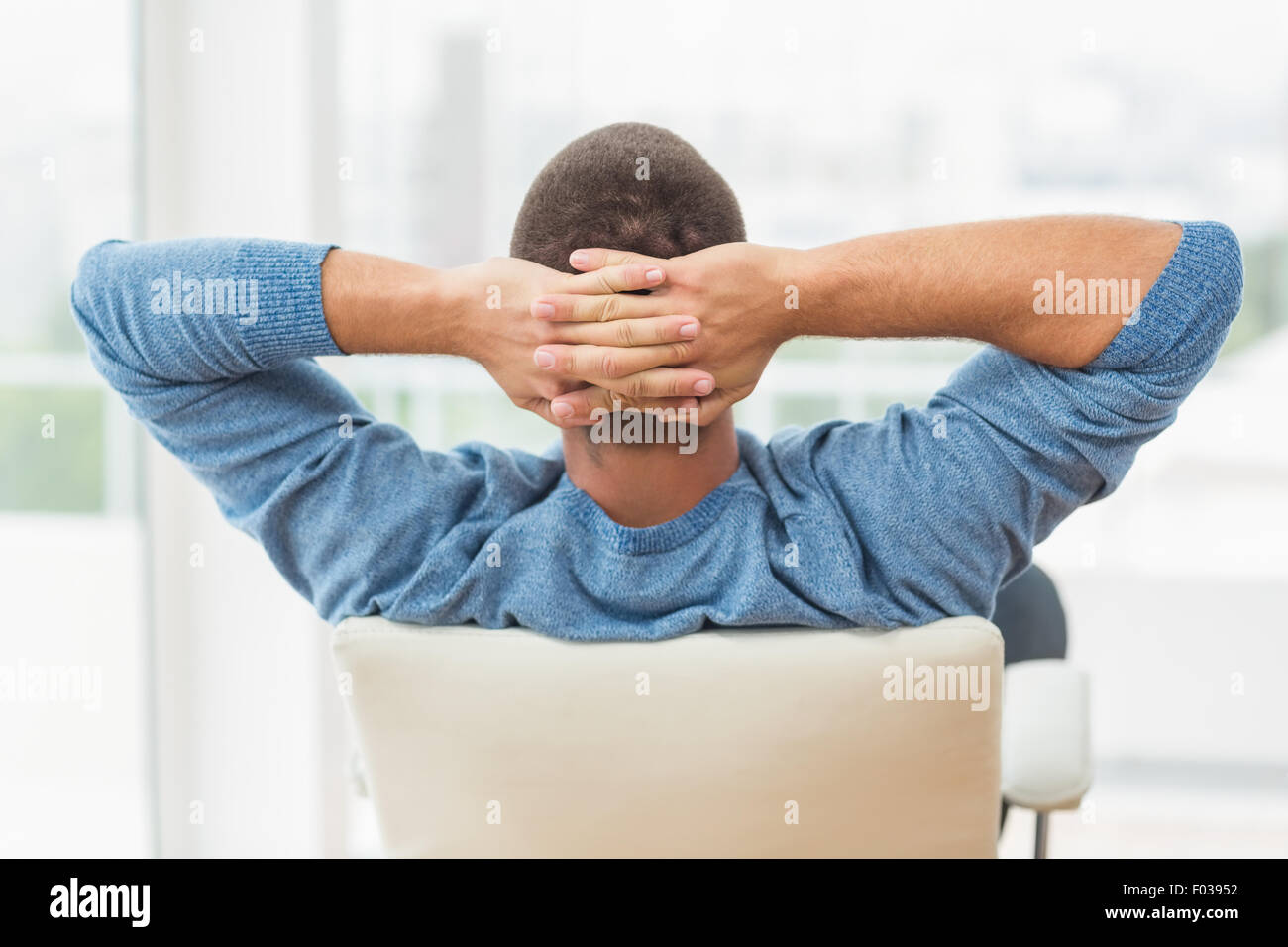 Relaxed creative businessman lying in a chair Stock Photo - Alamy