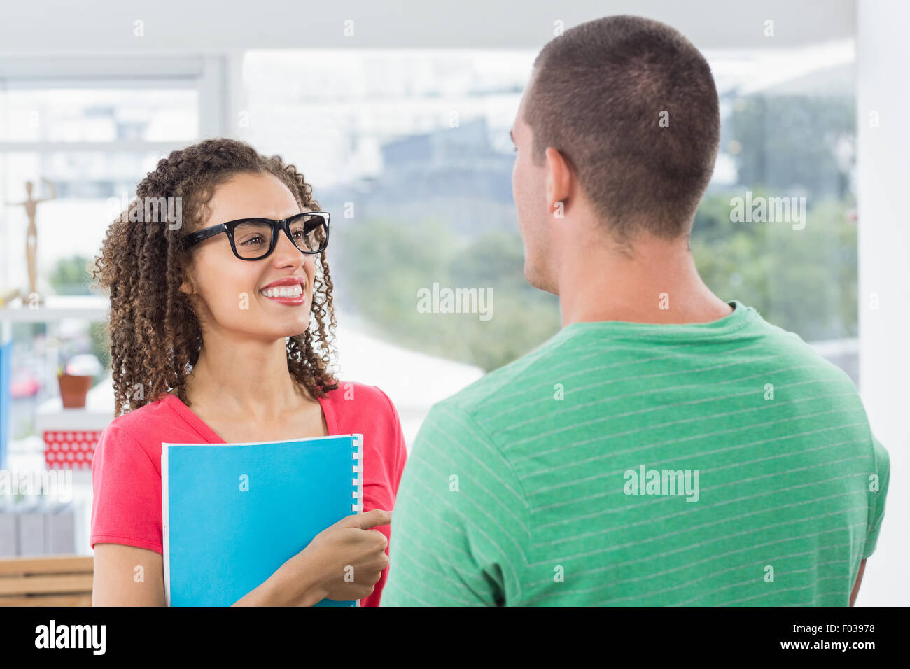 Casual business team looking at files Stock Photo - Alamy
